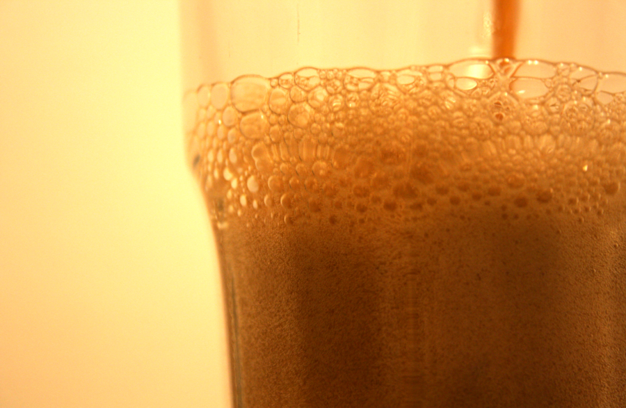 Guiness poured into a glass exhibits downward flow near the surface of ...
