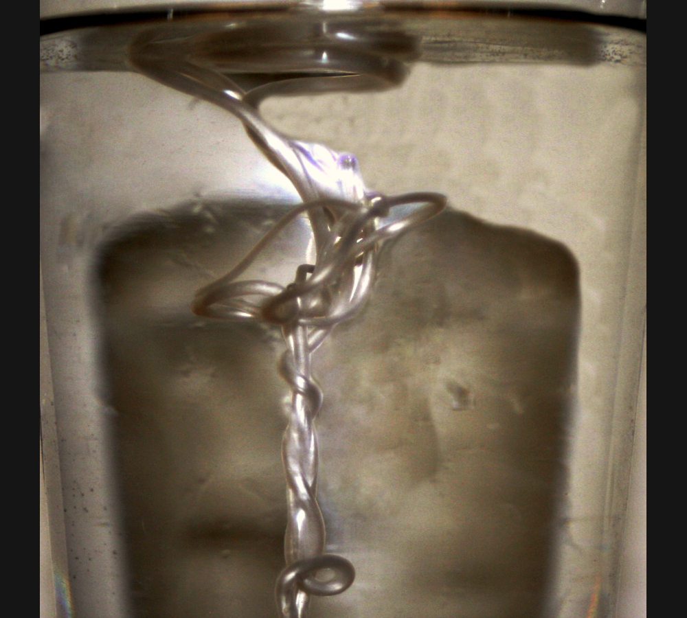 A thin stream of shampoo falling through cold water exhibits the 'rope ...