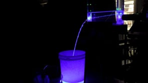 Total internal reflection in a water stream traps three lasers. As the ...