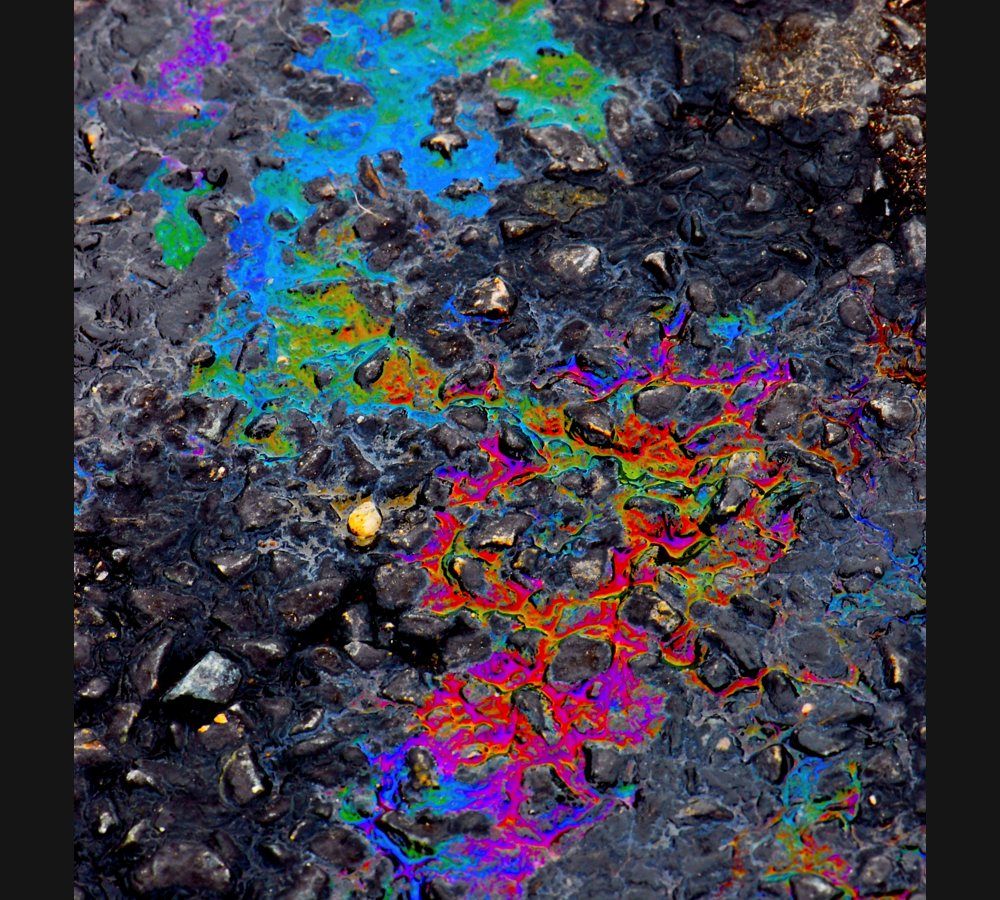 A thin film of motor oil on a puddle produces beautiful colors by ...