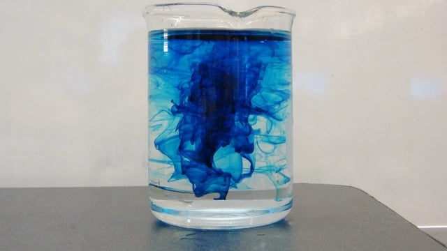 Heavy food dye dropped into a water vortex and viewed from the side ...