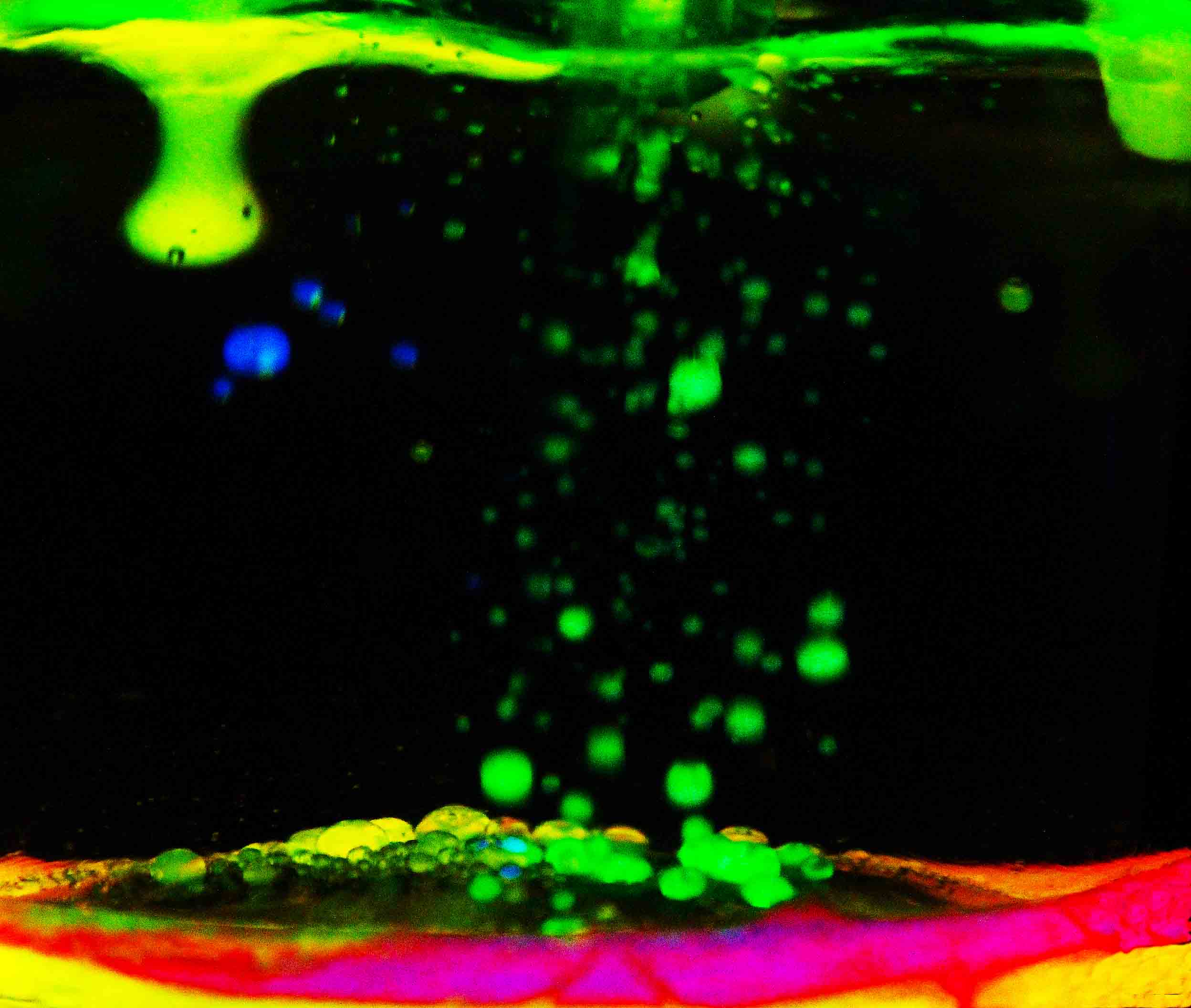 Chemiluminecent liquid from a glow stick falls in water. - Flow ...