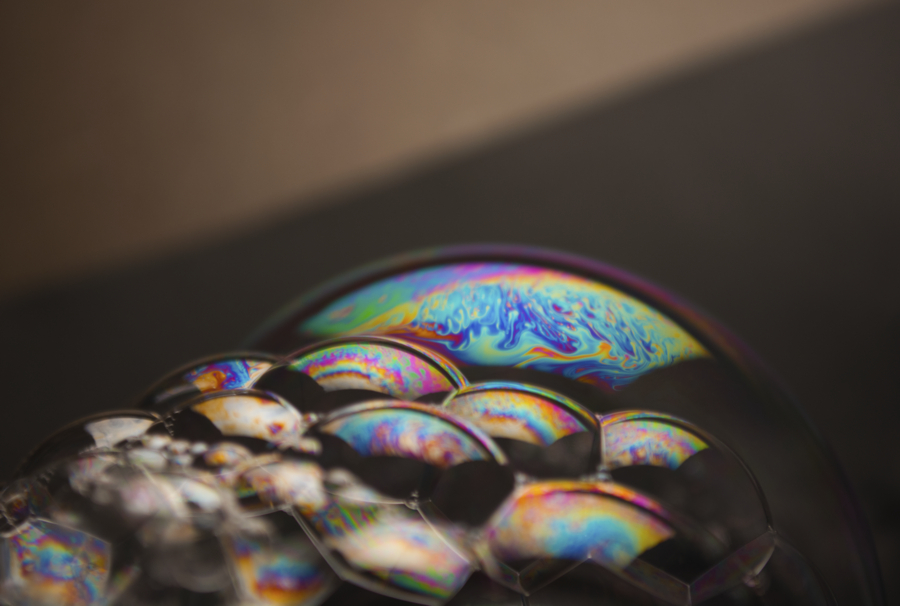 The rainbow of colors on a soap bubble indicates that the film ...