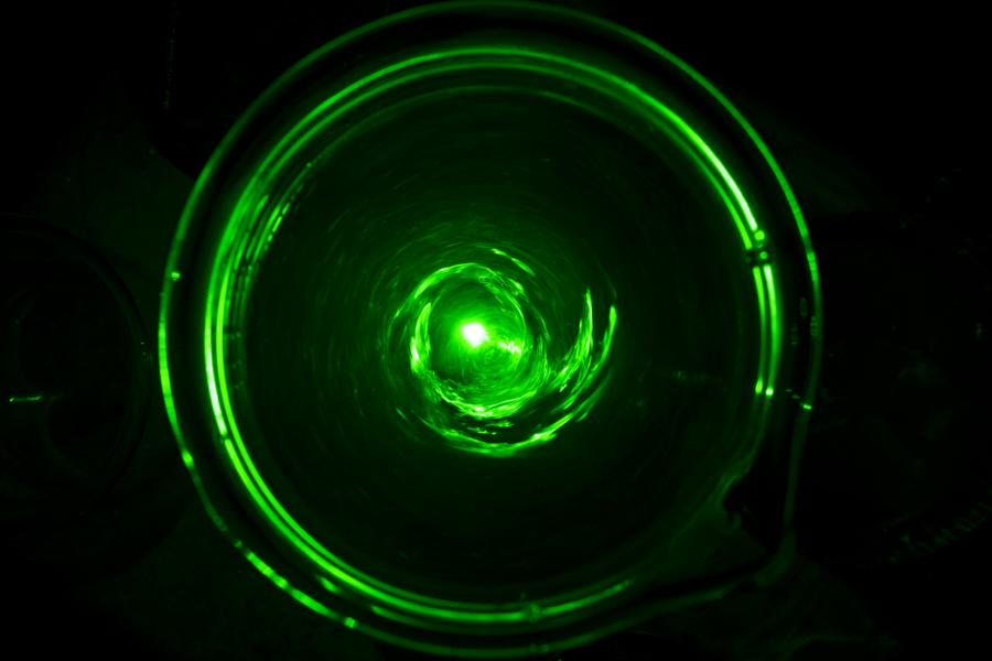 A stirrer creates a vortex with a conical water surface, viewed from ...