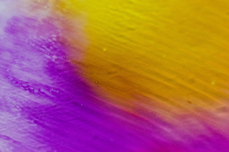 A thin layer of dyed corn syrup is rippled by additional fresh water ...