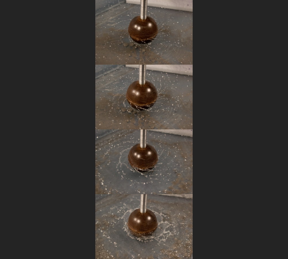 A sphere spinning in a shallow pool pumps water up along its surface ...