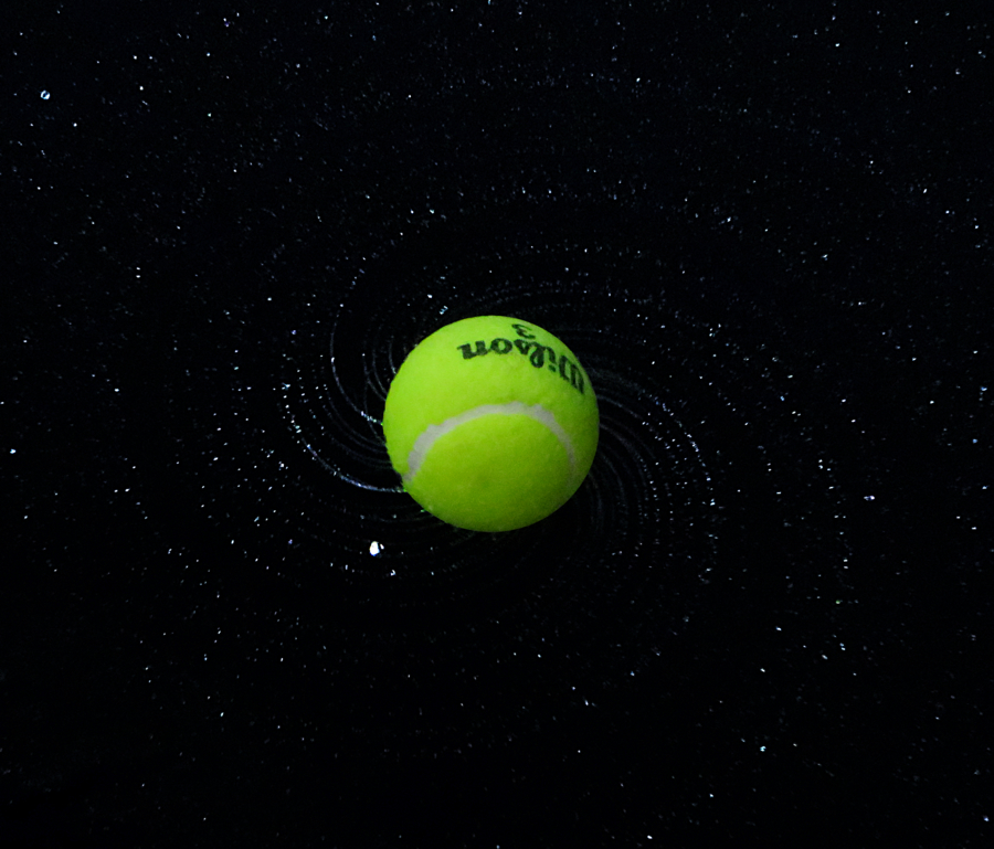Water thrown from a wet tennis ball forms spiral streams as each ...