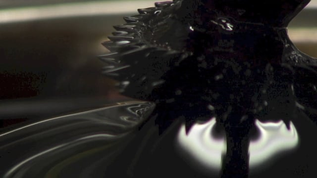 Ferrofluid climbs a magnetized steel sculpture, viewed from the side. - Flow Visualization
