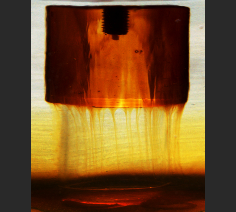 Molasses streams off an underwater upright cylinder, illustrating long ...