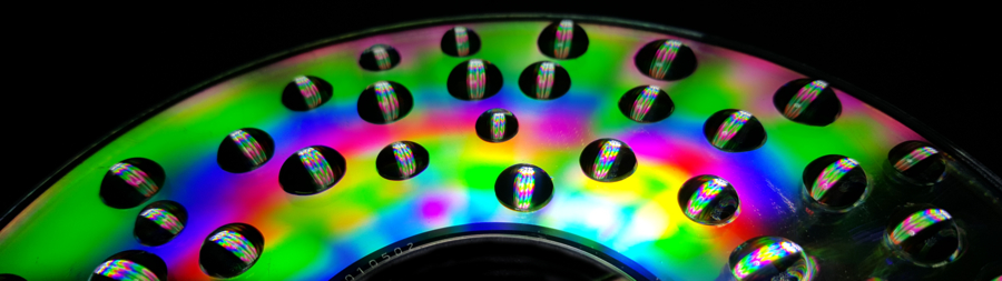 Water droplets on a CD bead up and display refraction, reflection ...